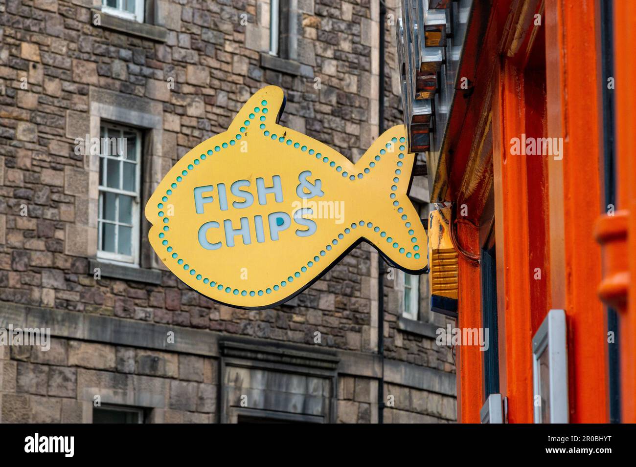 A yellow quirky sign outside a fish and chip shop in Old Town ...