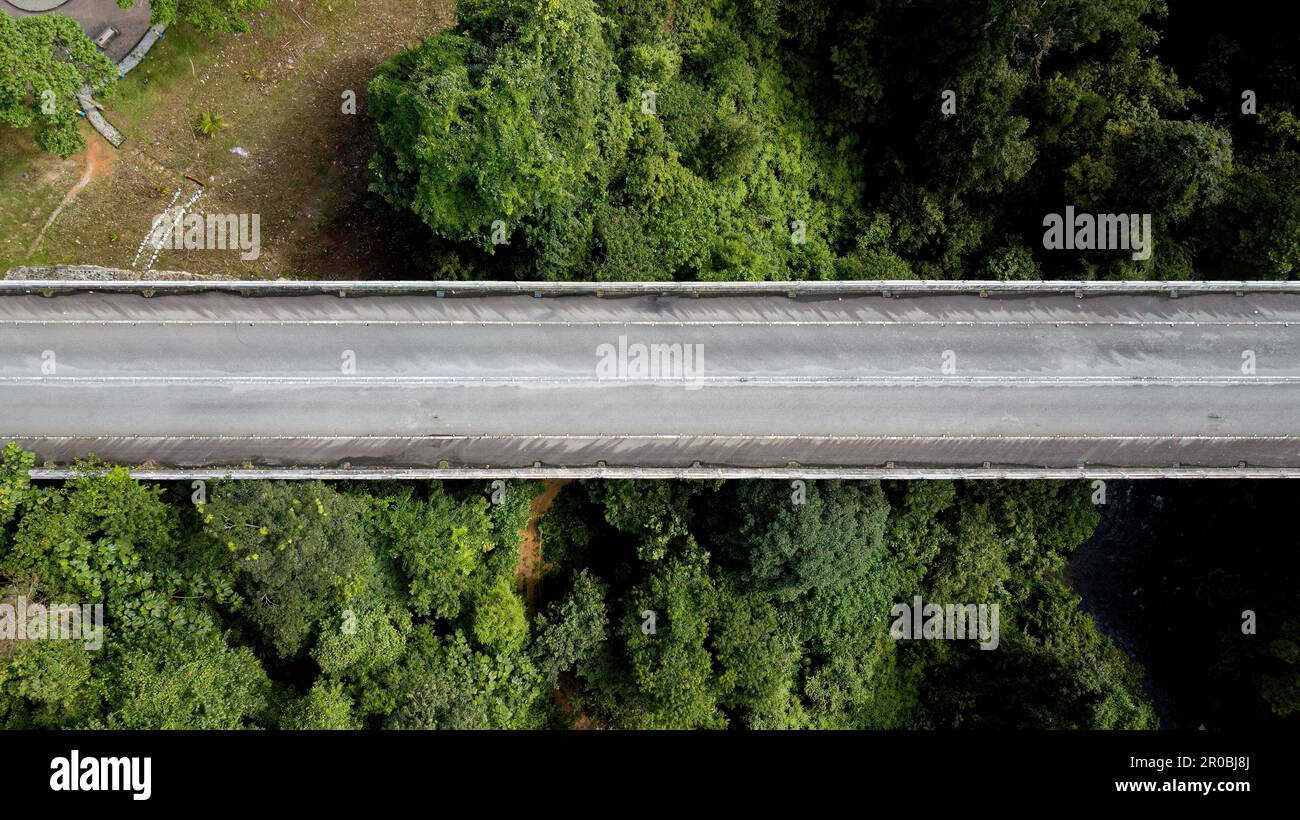 Empty elevated road across the rainforest mountains in Hulu Selangor ...