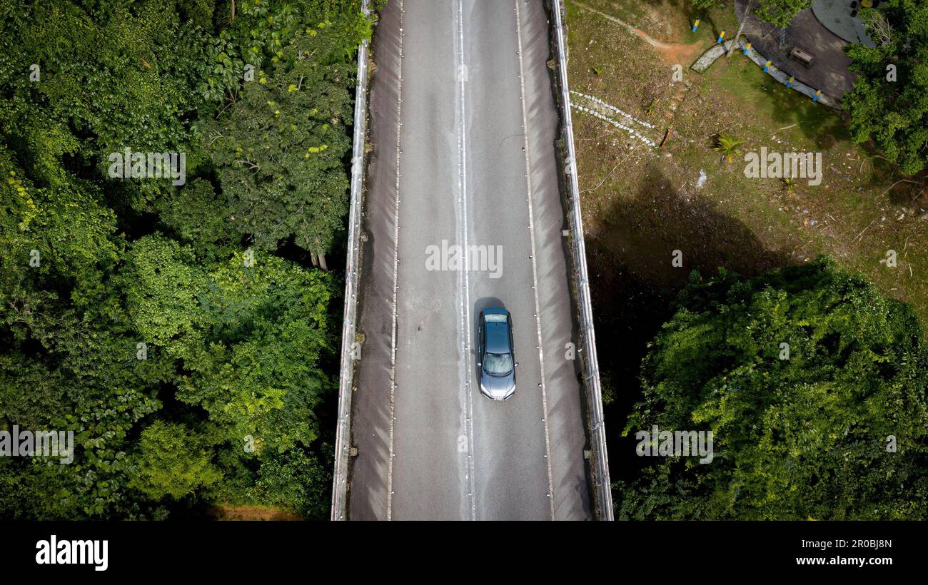 car moving on the elevated road across the rainforest mountains in Hulu ...