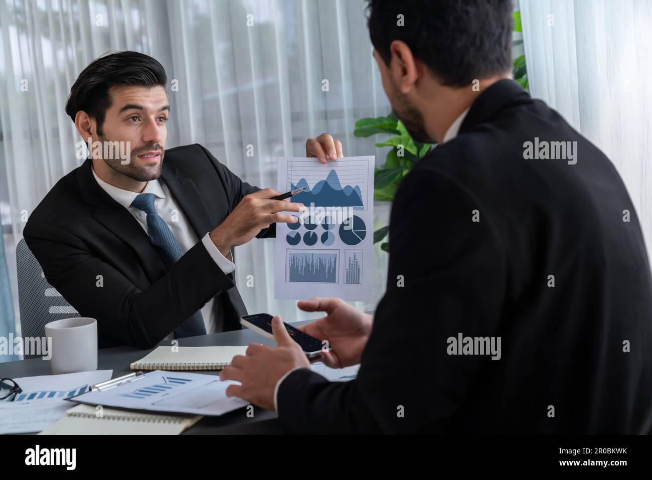 Busy analyst team discussing financial data on digital dashboard ...