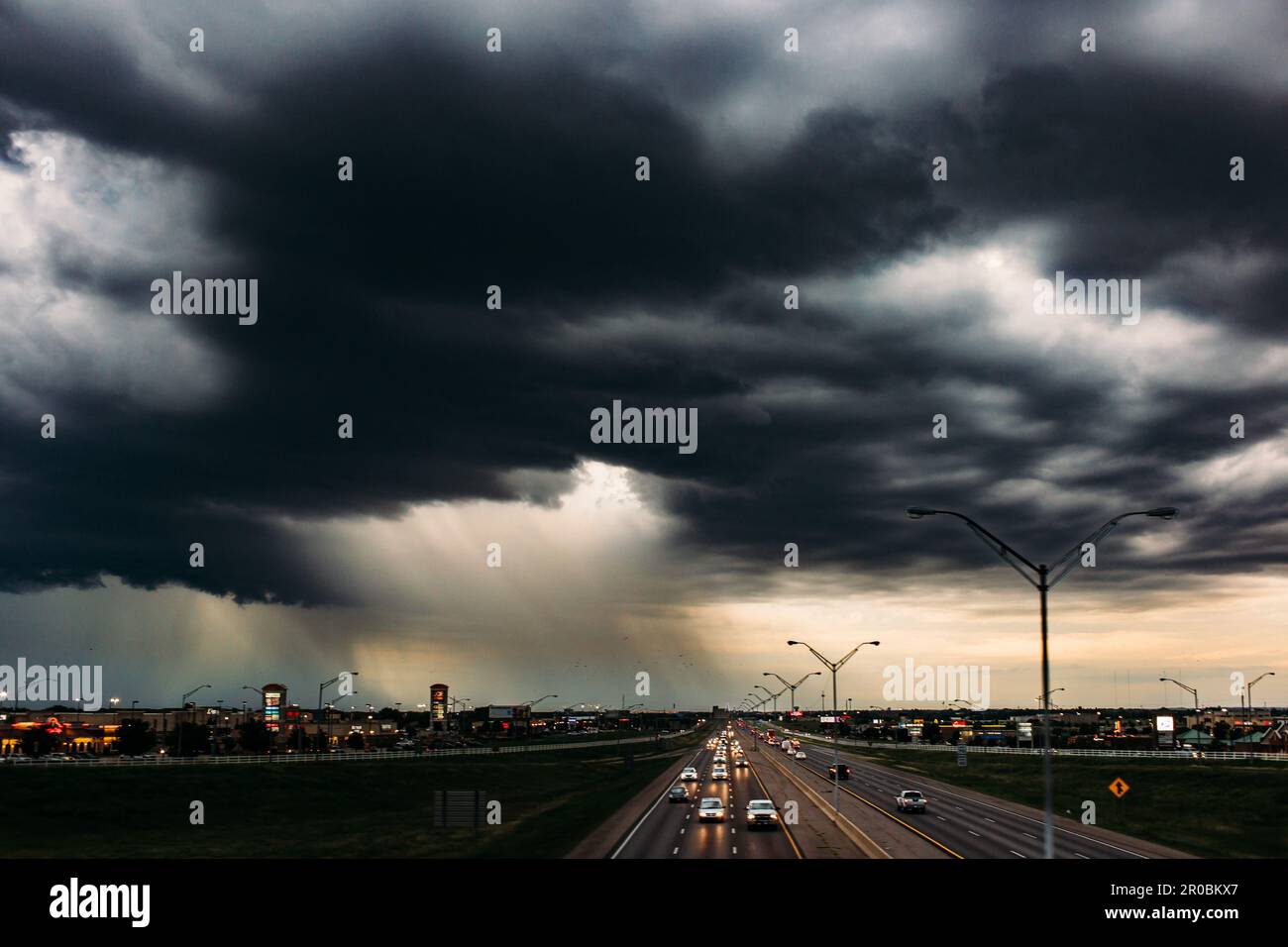 Clouds opening with rain falling over the city Stock Photo - Alamy