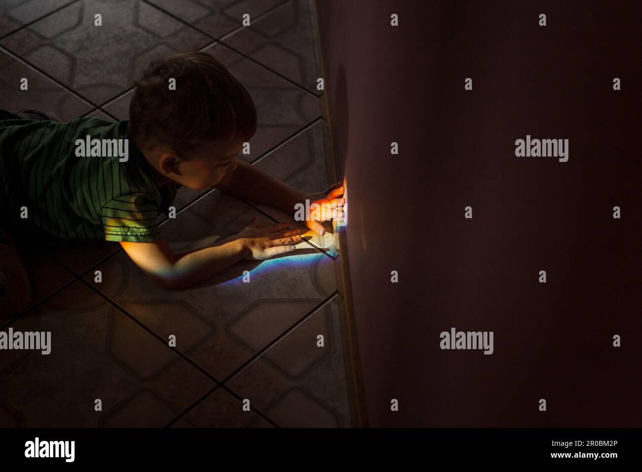 Child touching rainbow light on the wall Stock Photo - Alamy