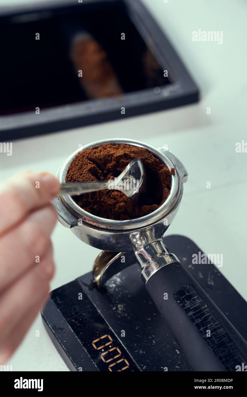 Freshly ground espresso getting measured out on a scale Stock Photo - Alamy