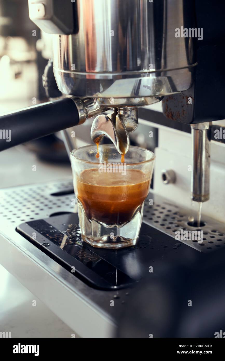 A single espresso shot being pulled from an espresso machine Stock ...