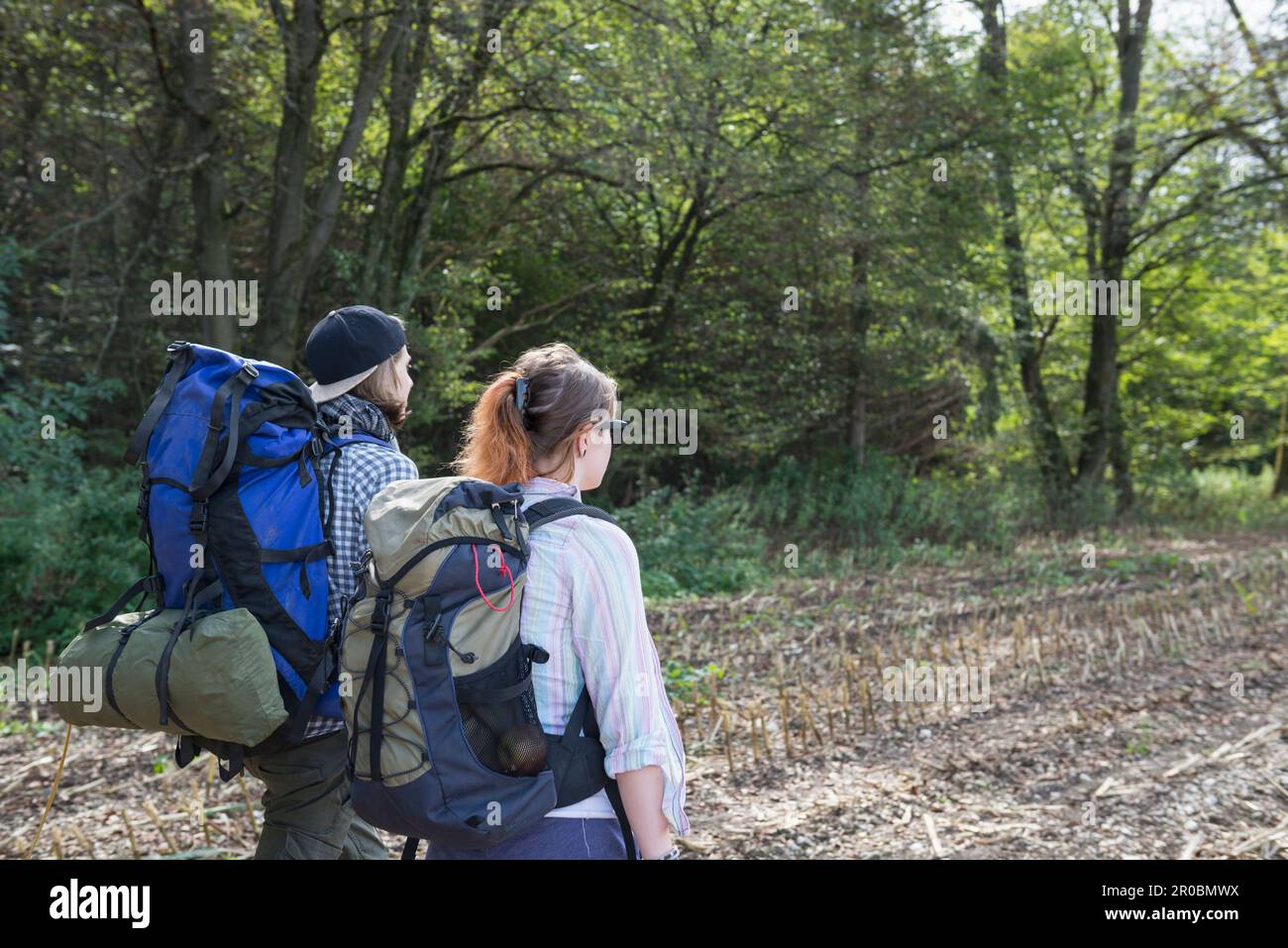 Young couple walking with backpack in a forest, Bavaria, Germany Stock ...