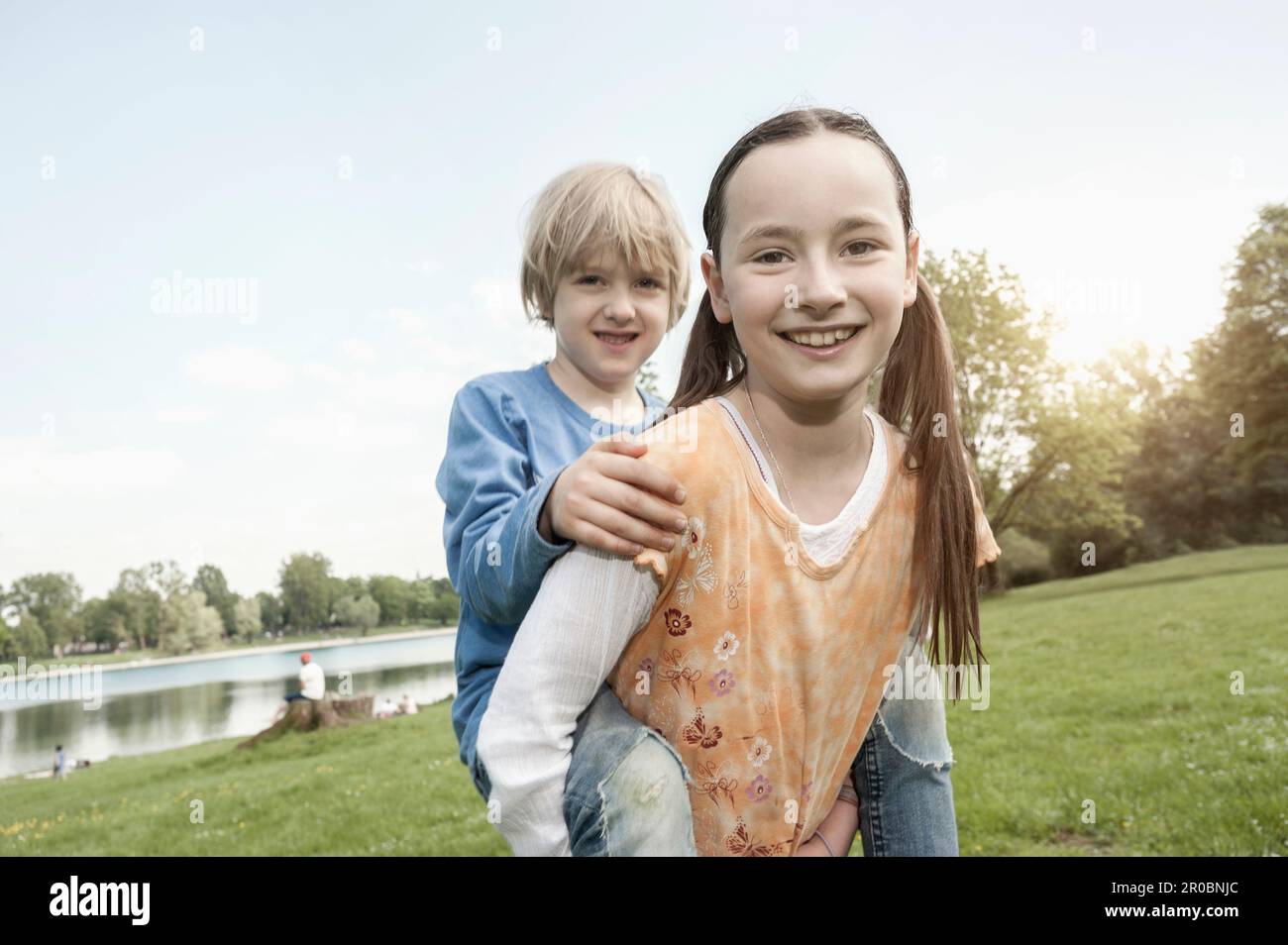 Brother and sister having fun together in a park, Munich, Bavaria ...