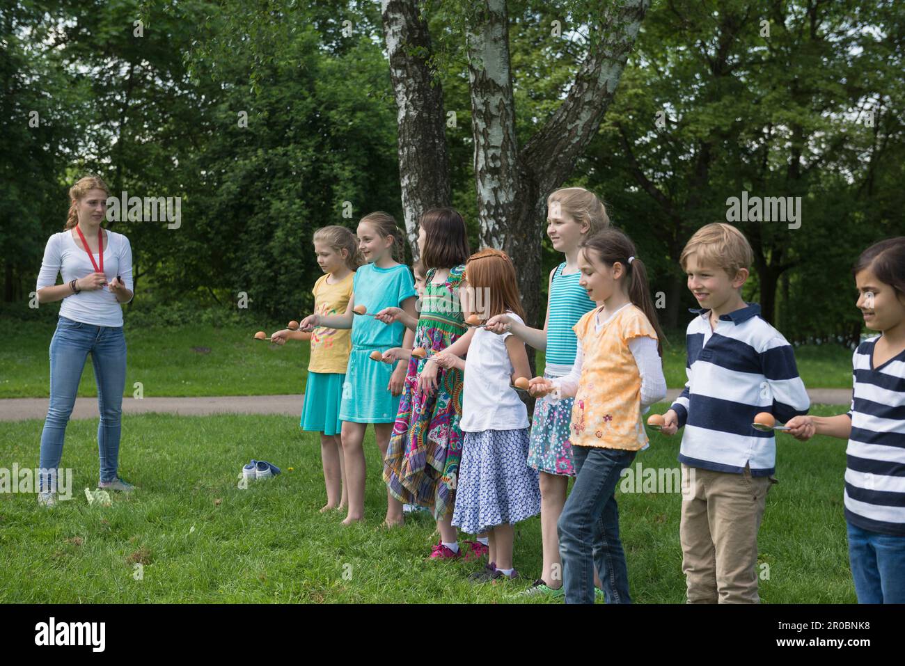 Group of children wait in a row to start the egg race, Munich, Bavaria, Germany Stock Photo - Alamy