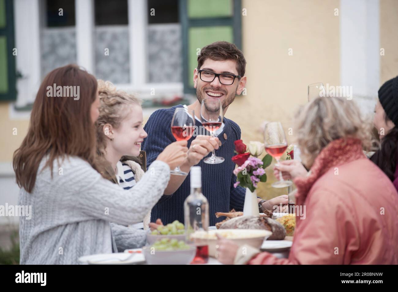 Family and friends enjoying outdoor party at farmhouse, Bavaria ...