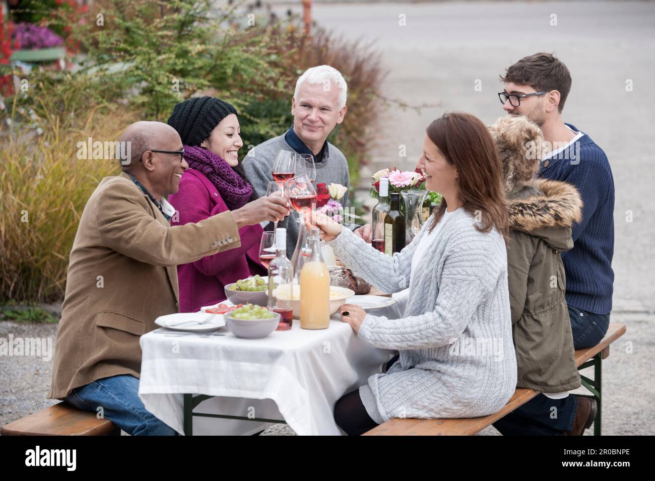 Family and friends enjoying outdoor party at farmhouse, Bavaria ...