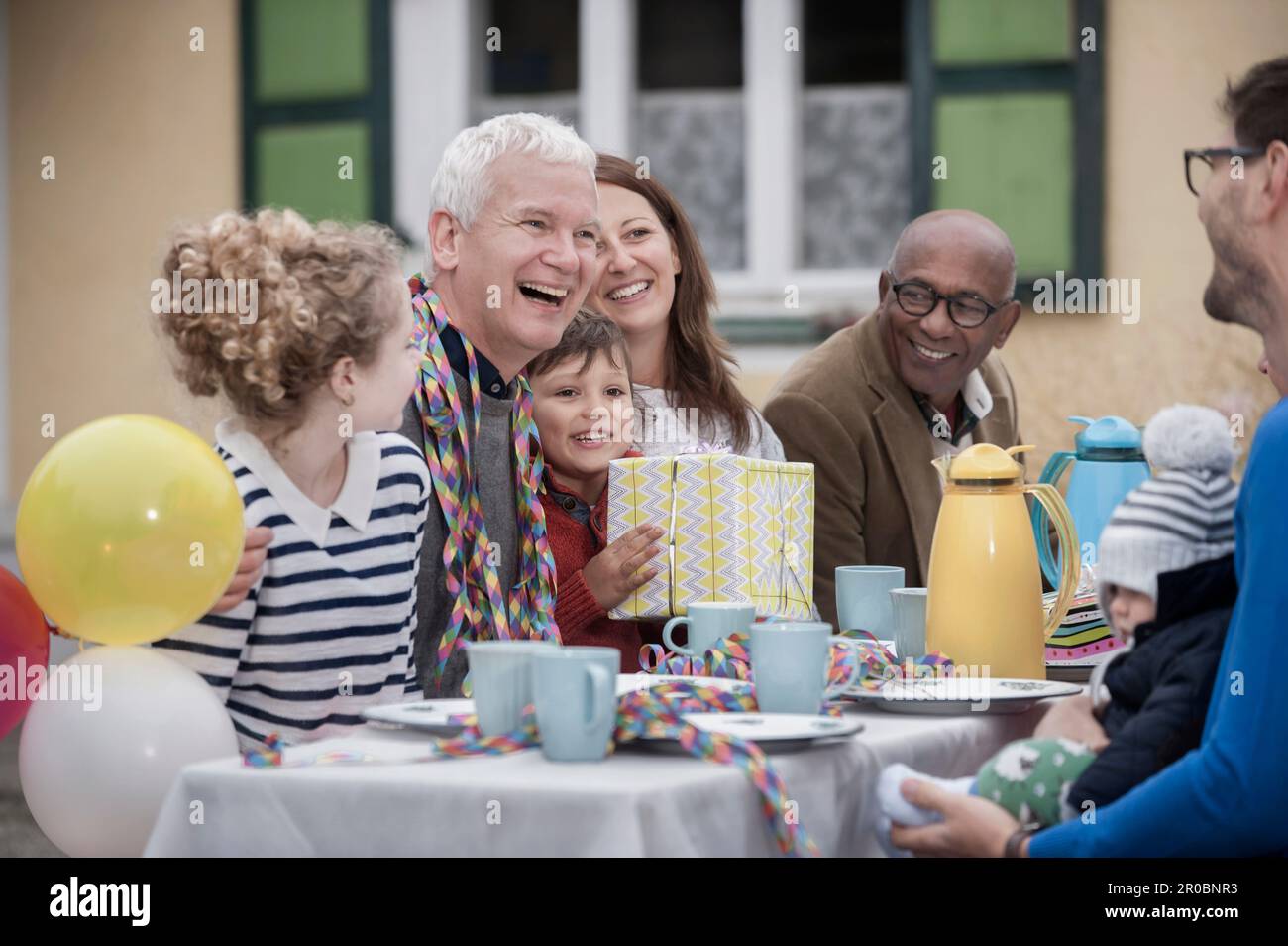 Grandfather with his family laughing on his birthday party, Bavaria ...