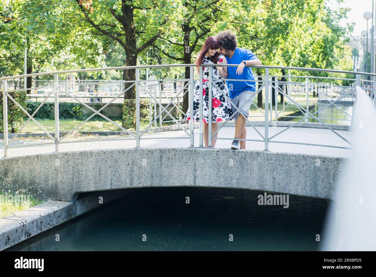 Couple standing together on bridge Stock Photo - Alamy