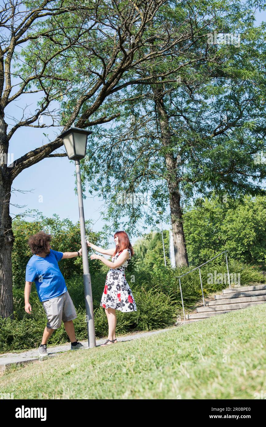 Couple dancing around street light Stock Photo - Alamy