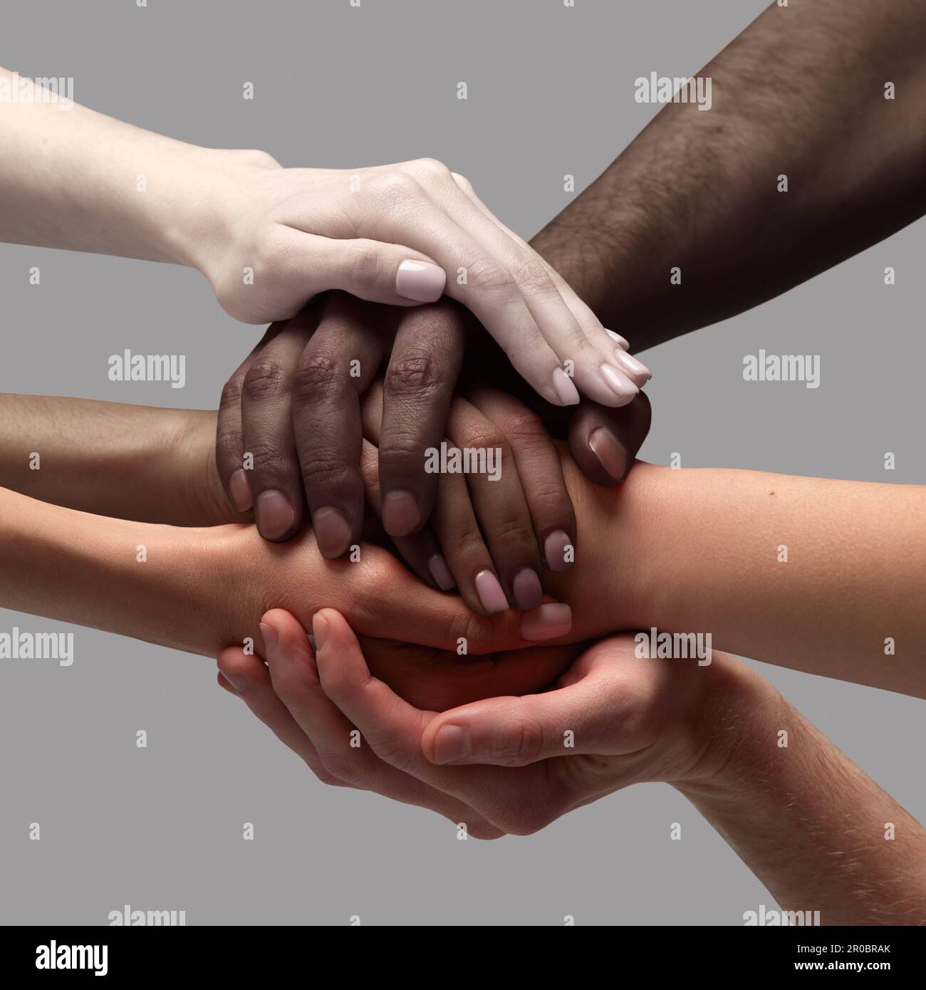 Support and care. Human hands of different race, skin color holding ...