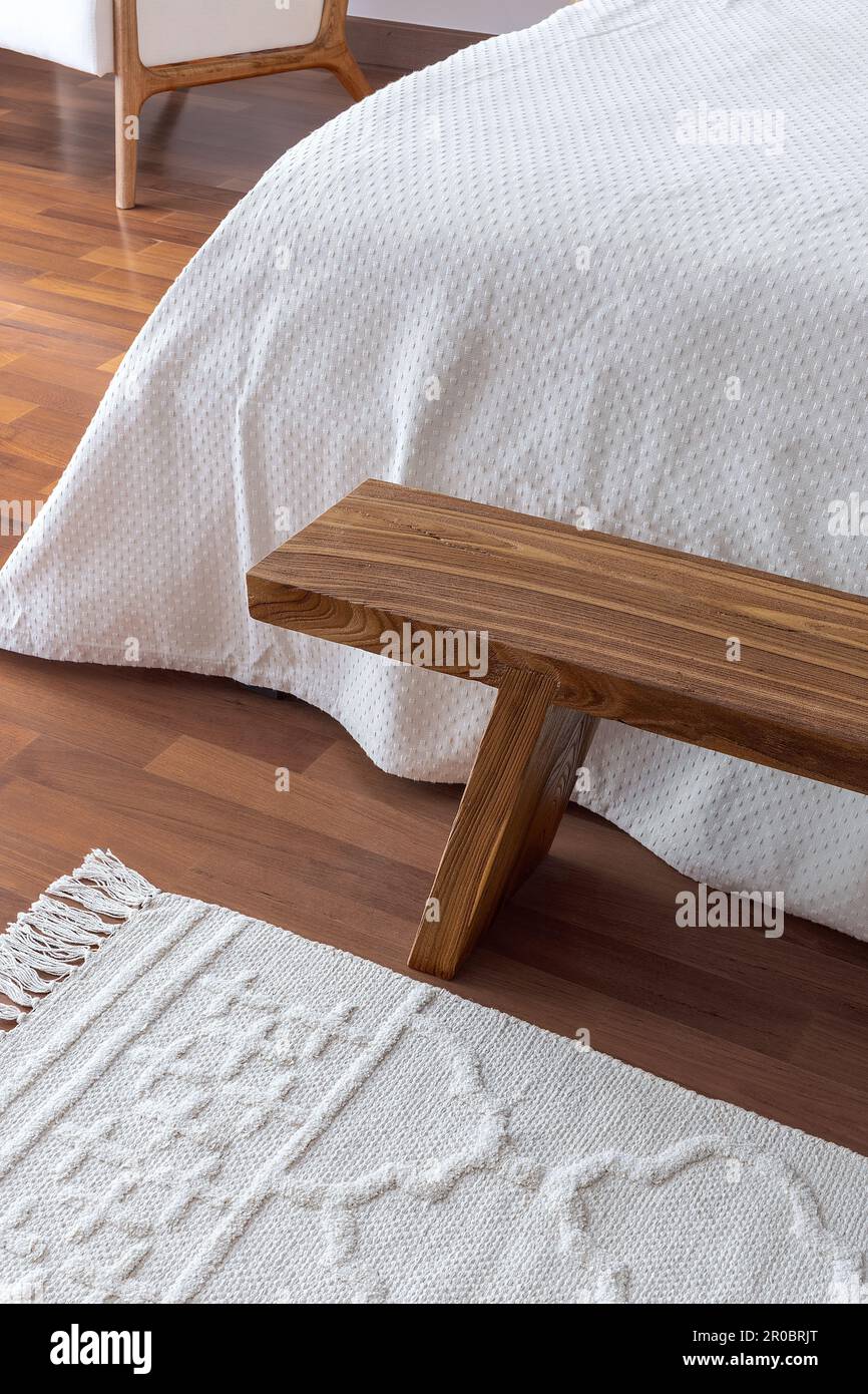 Handmade elm bench in the bedroom Stock Photo - Alamy