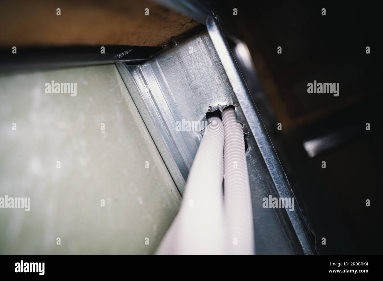 The wires in the protective corrugated pipe are led through the hole ...