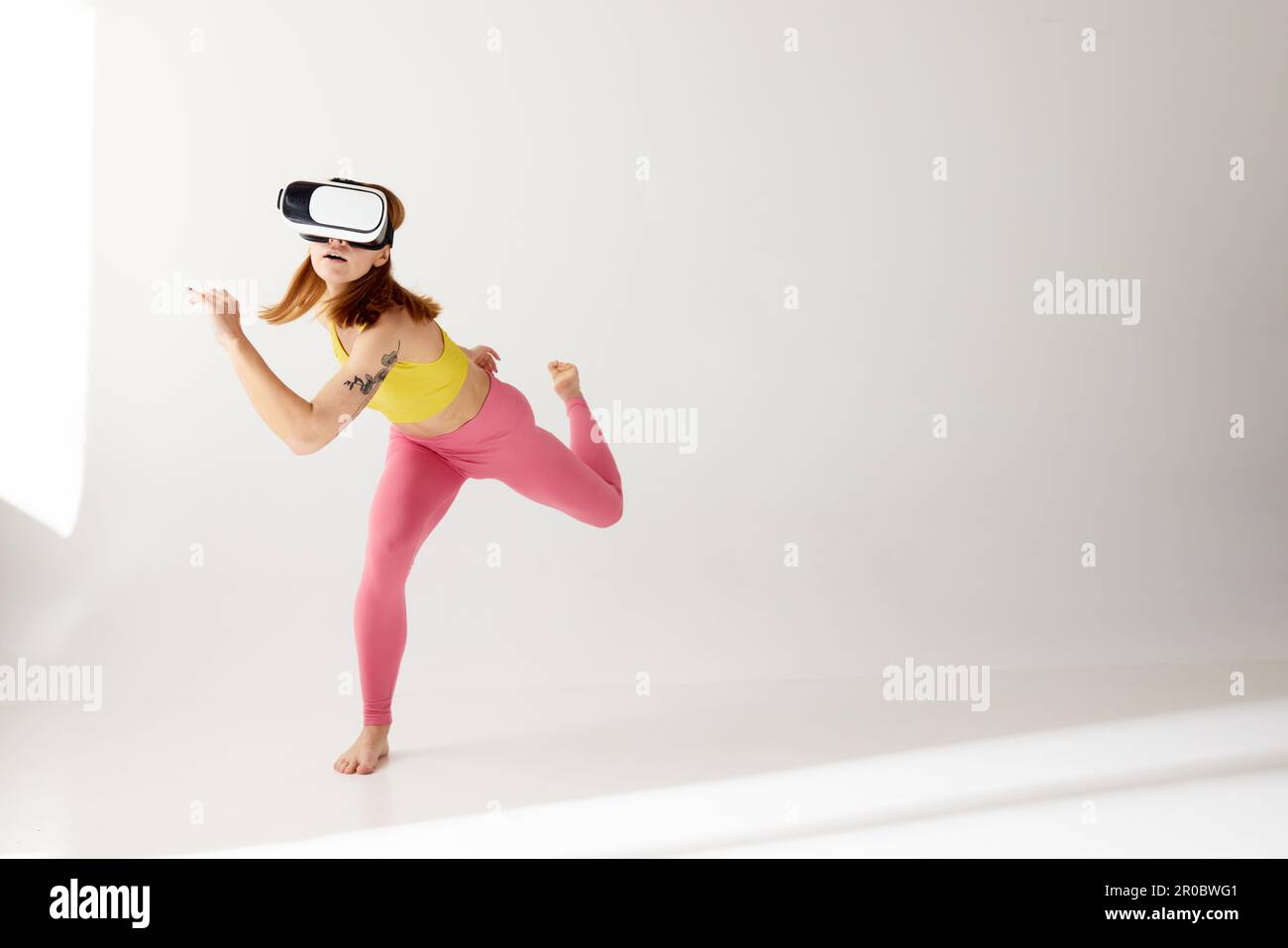 Portrait with girl wearing sportswear and VR glasses, training over ...