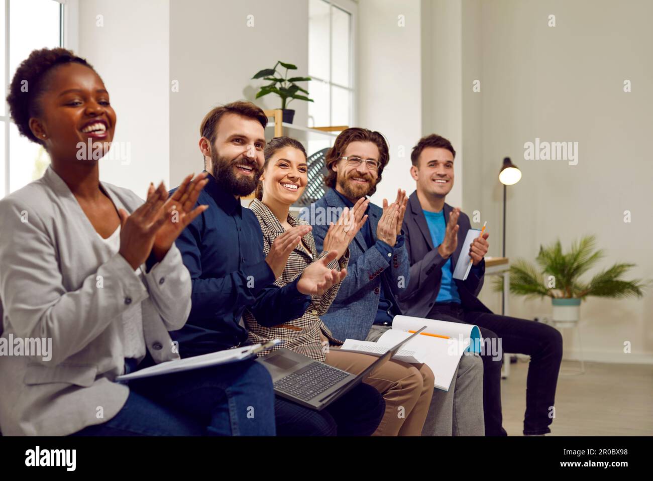 Professional audience applauding the speaker after a good presentation ...