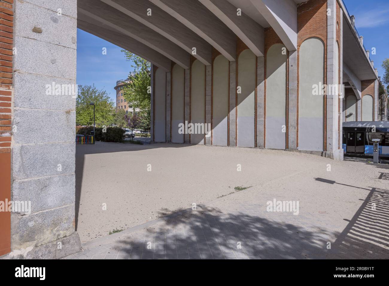 Lower part of a bridge with an urban street passing under it Stock ...