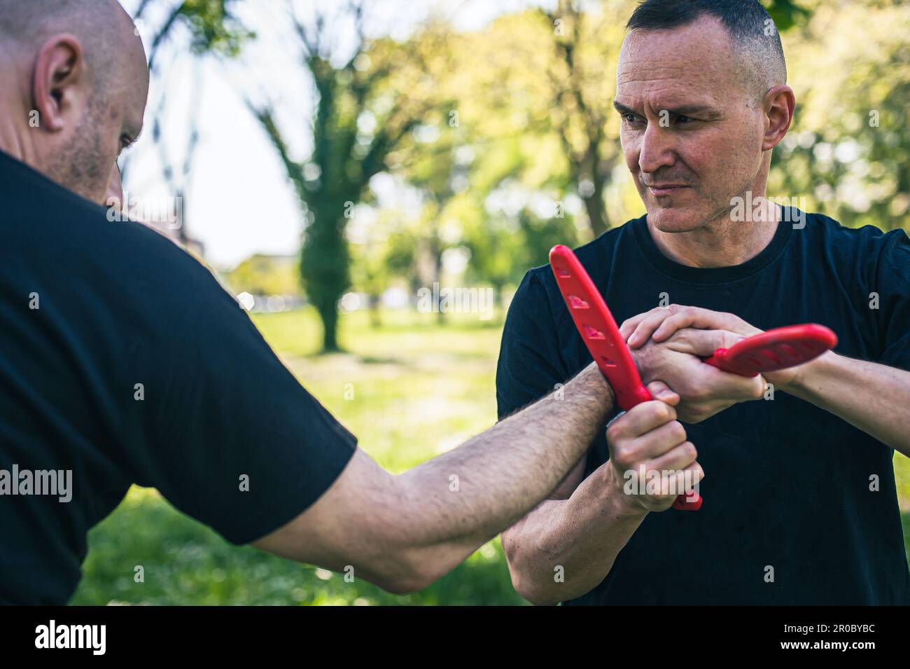 Knife attack self-defense. Techniques of disarming knife attacker. Weapon disarm training Stock ...