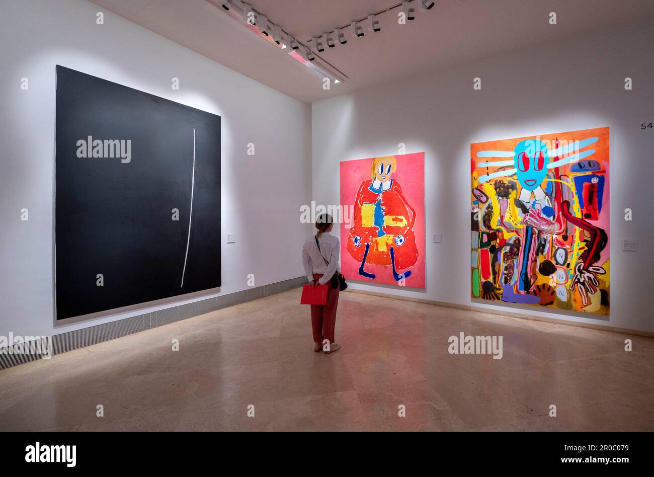 A woman observes one of the first retrospectives of André Butzer (1973 ...