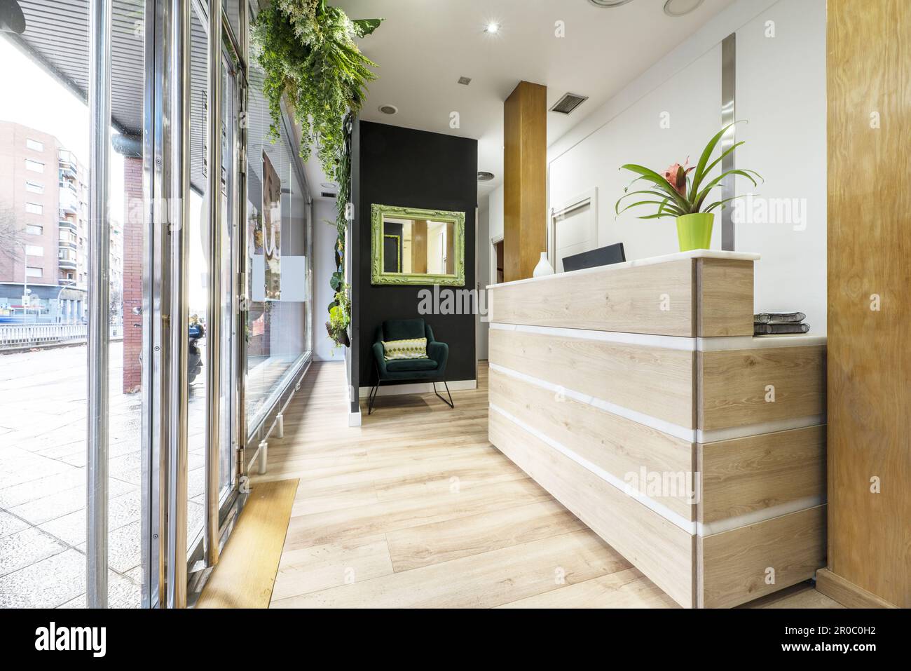Reception desk of a business with light wooden furniture and natural ...