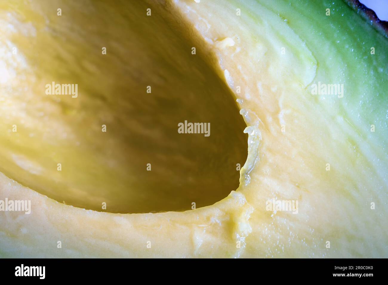 Cut open avocado without nut closeup Stock Photo - Alamy