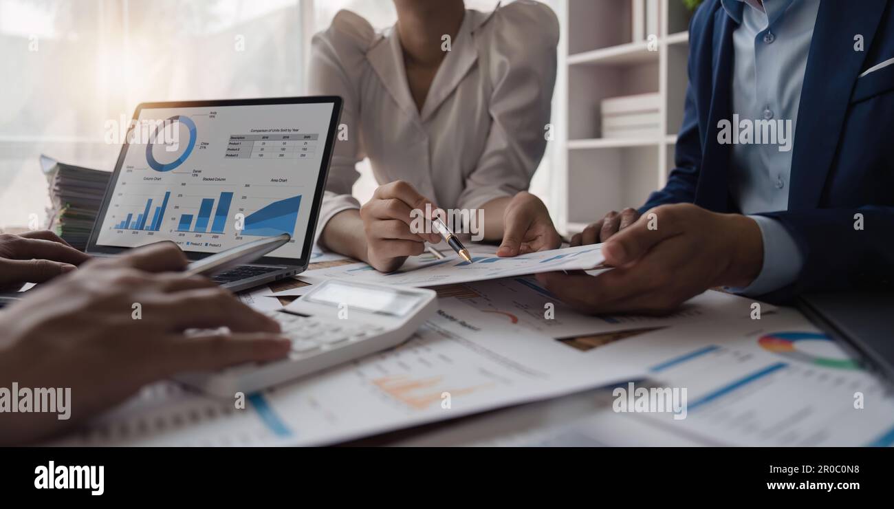 Business team using a calculator to calculate the numbers of statistic ...