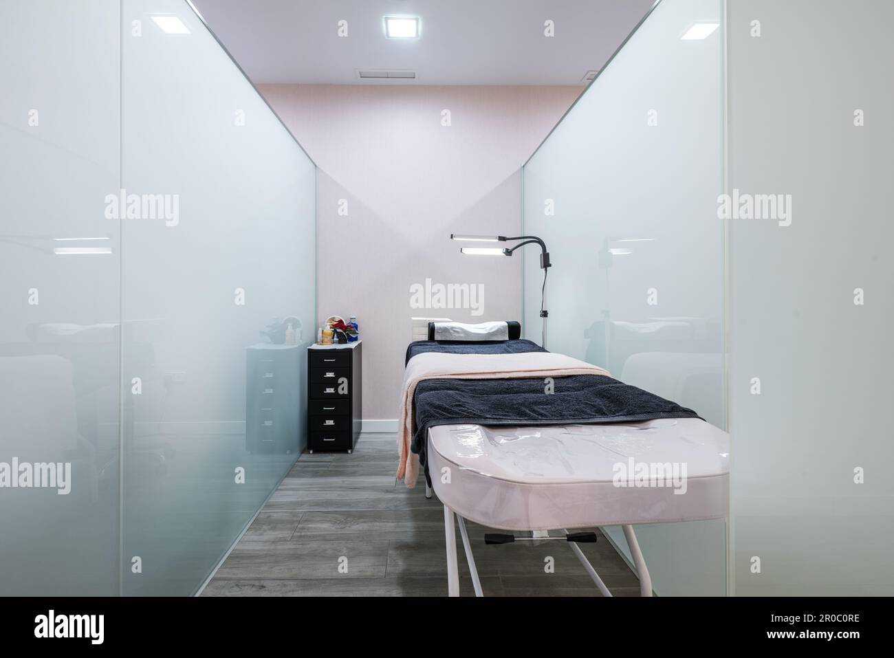 An individual treatment cabin with a stretcher and tempered glass walls ...