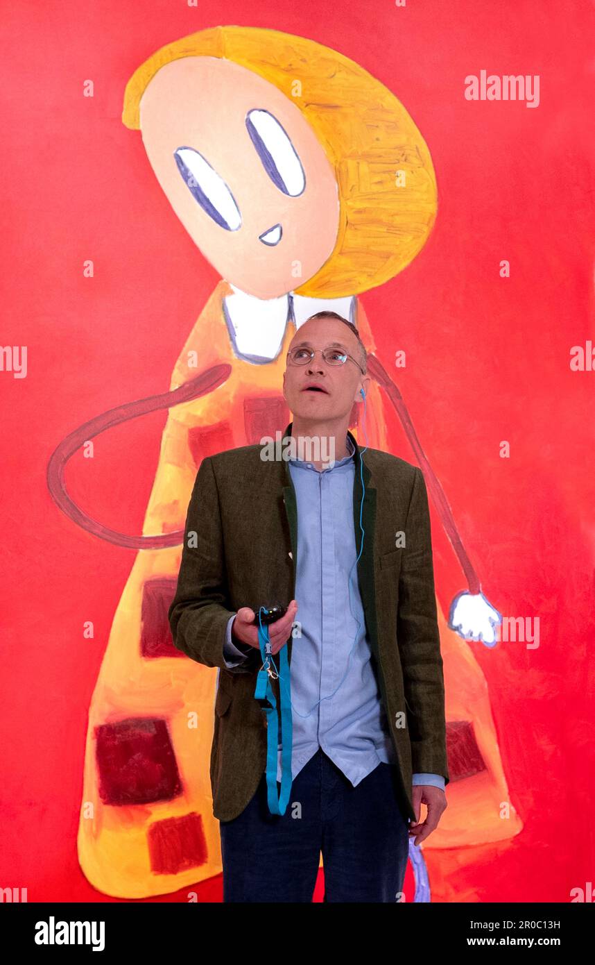 Artist André Butzer poses next to one of his first retrospective ...