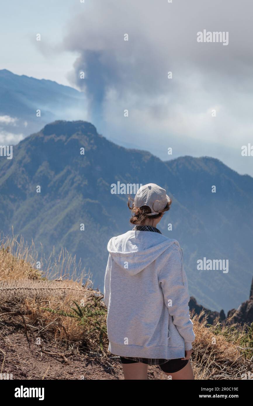 Tourist girl watching Cumbre Vieja volcanic eruption on the island of ...