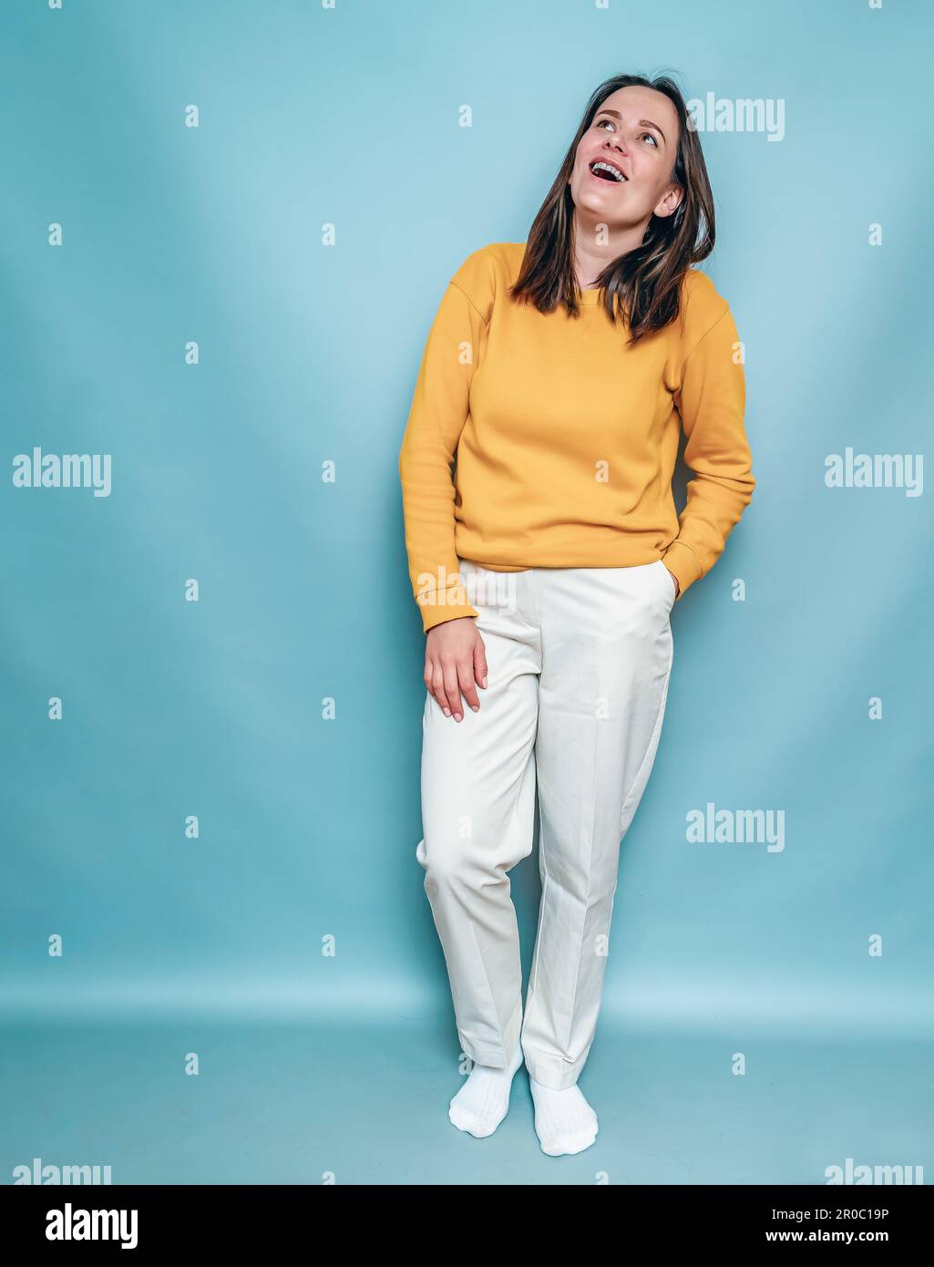 Modern woman laughs. Blue background. Positivity, good mood, problem ...