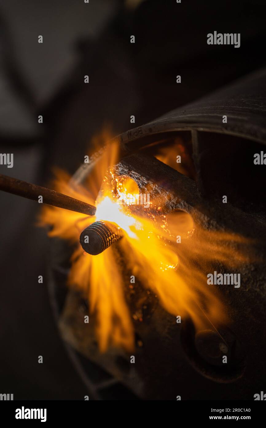 Man welding a plate in a workshop with high heat Stock Photo - Alamy
