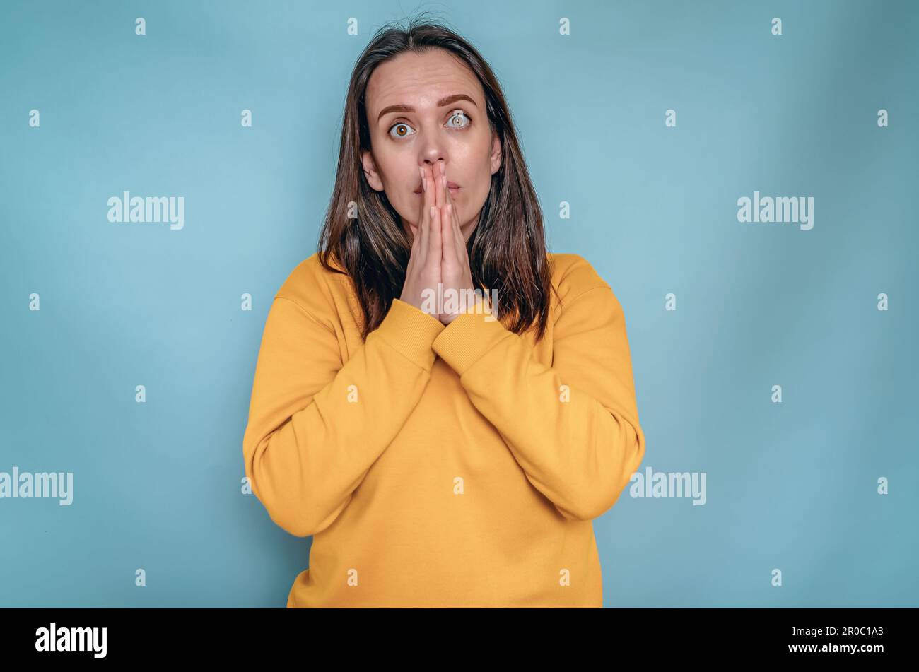 Surprised shocked woman holding her hands near her face. Emotional ...
