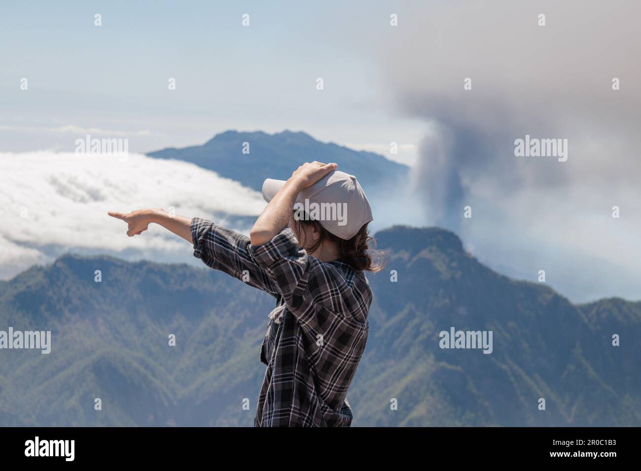 Tourist girl pointing next to Cumbre Vieja volcanic eruption on the ...