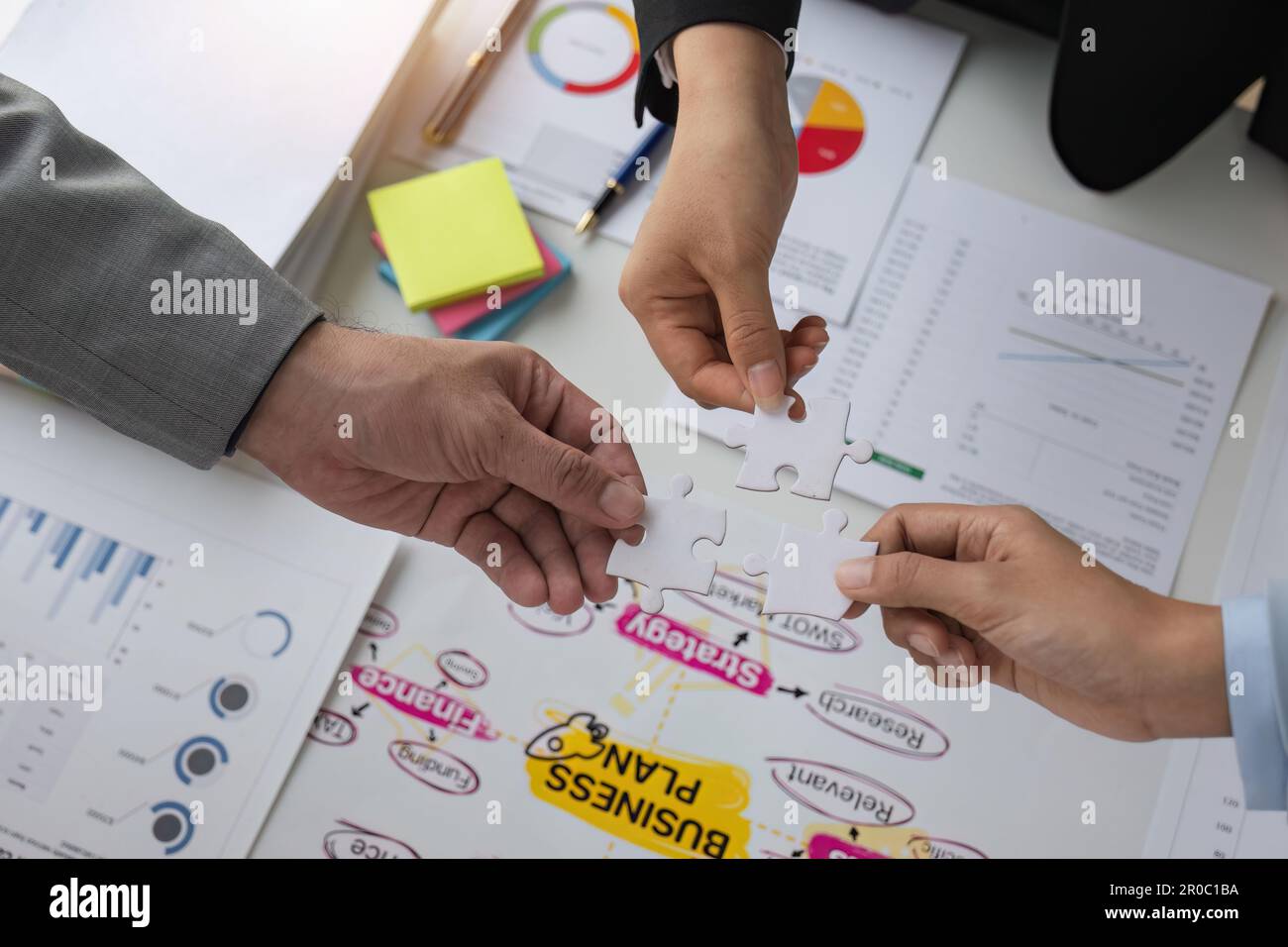 Closeup top view business team of office worker holding jigsaw puzzle ...