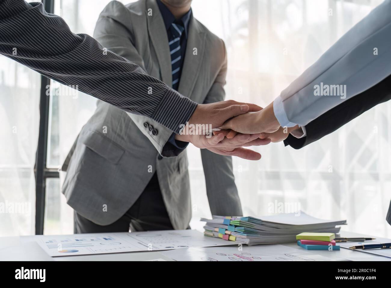 Analyst business team putting hand together after successfully analyzed ...