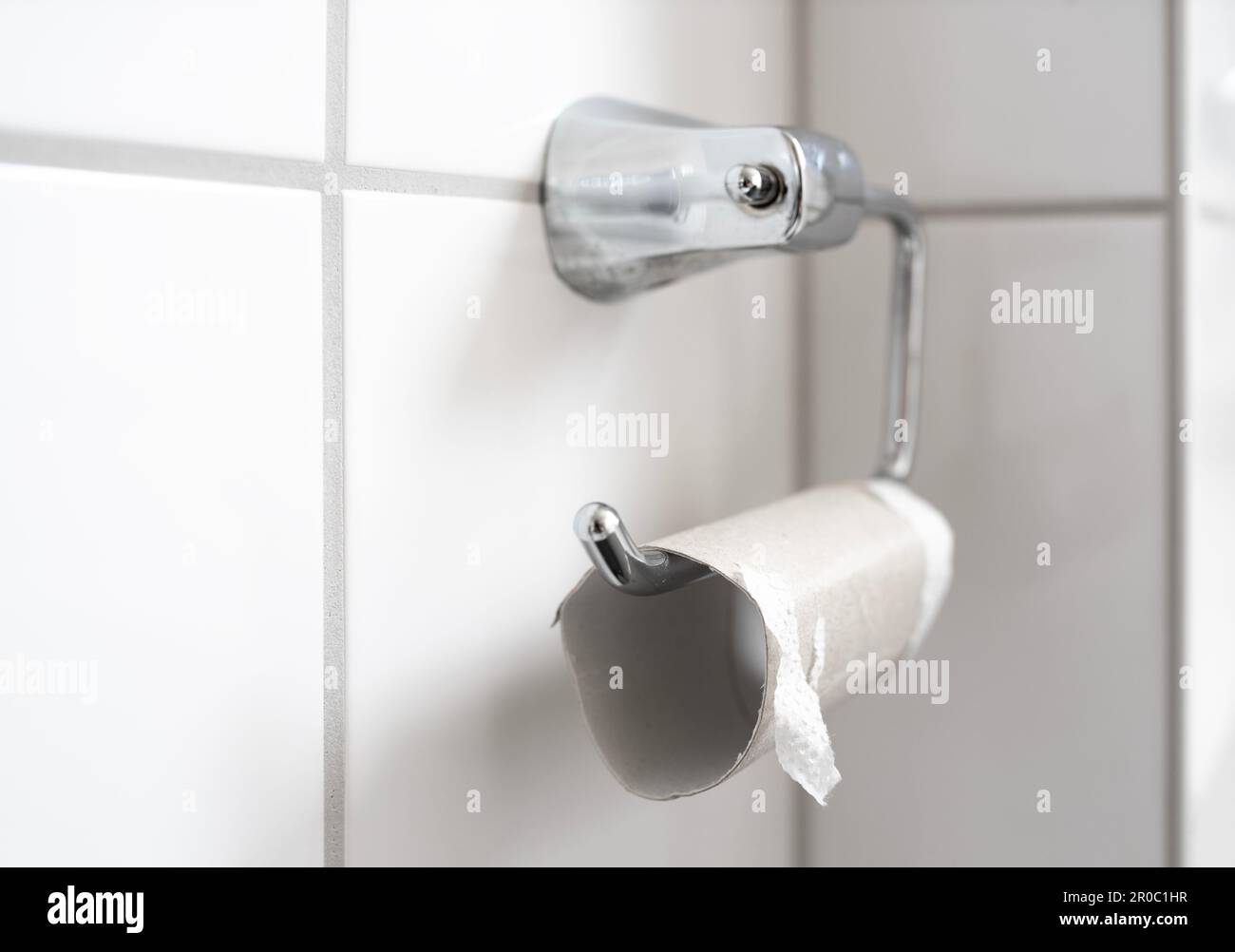 empty toilet paper roll on bathroom tissue holder, running out of ...