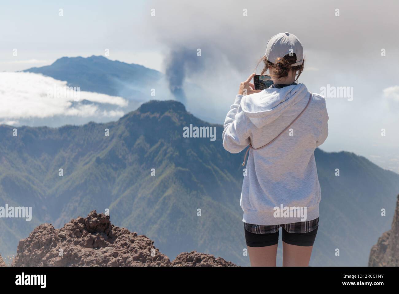 Tourist girl takes picture of Cumbre Vieja volcanic eruption on the ...
