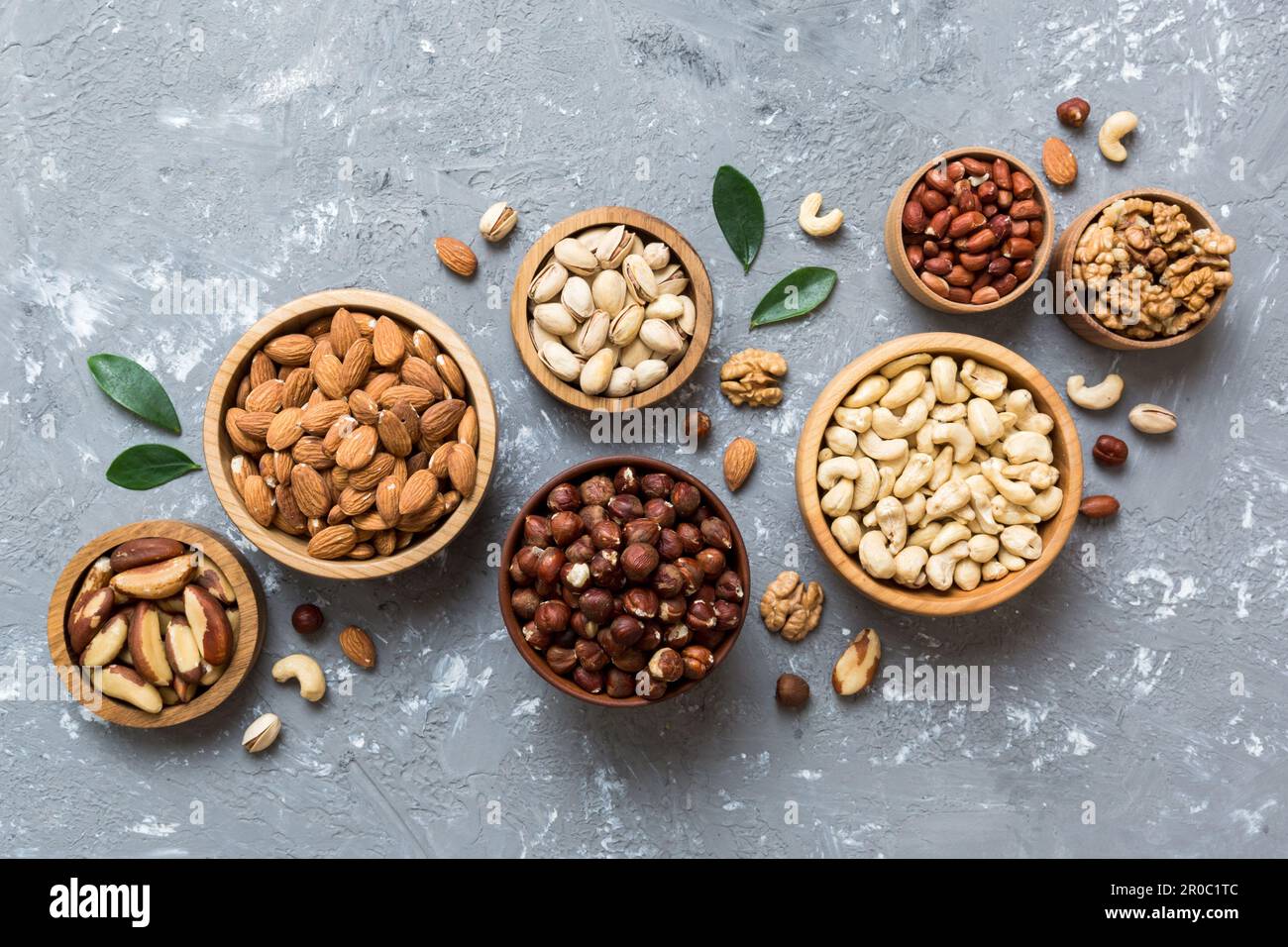 mixed nuts in wooden bowl. Mix of various nuts on colored background ...