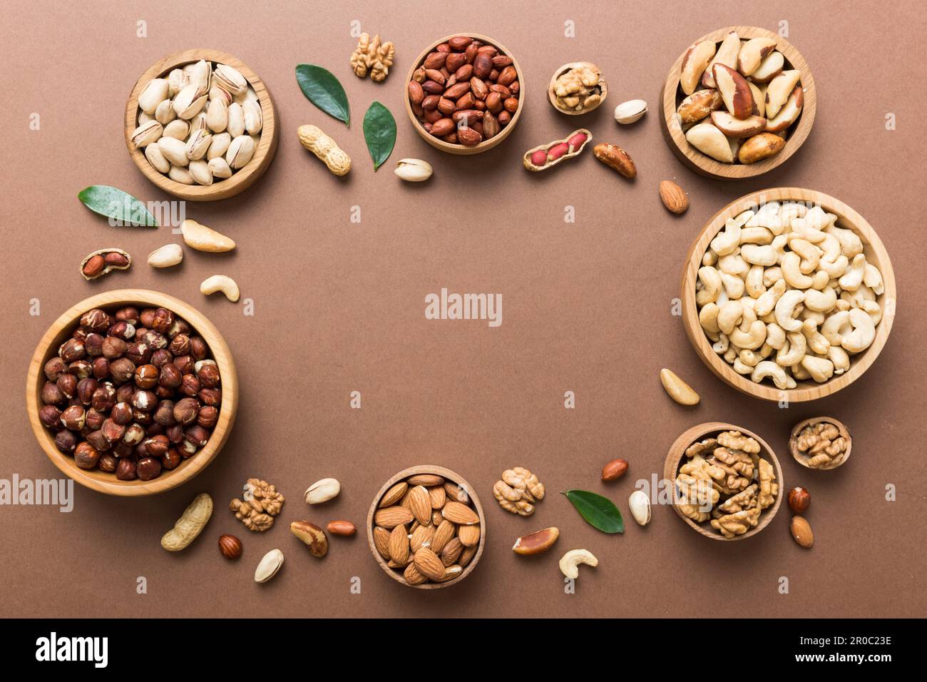 mixed nuts in wooden bowl. Mix of various nuts on colored background ...