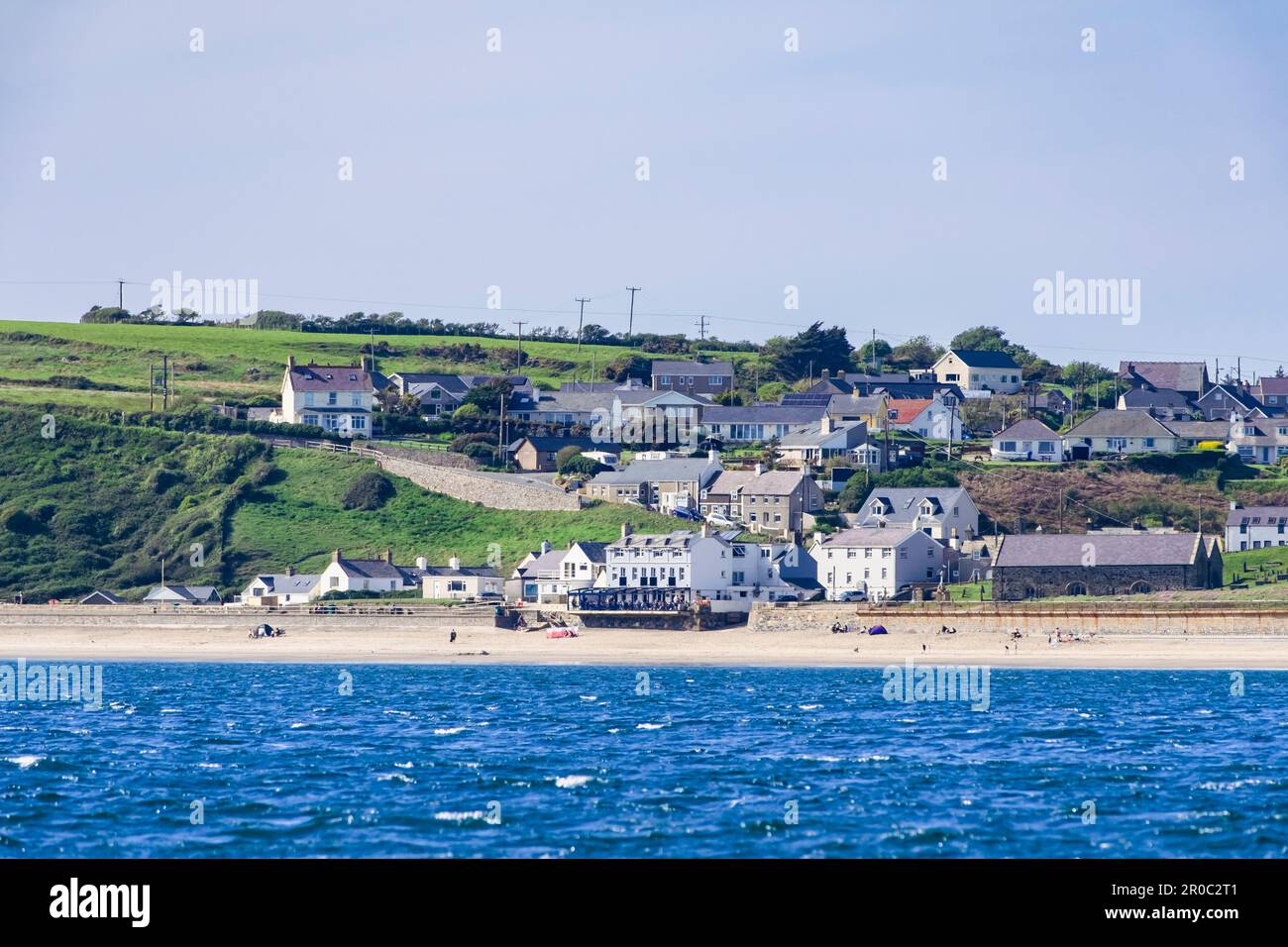 Offshore view across sea to beach and seafront in Aberdaron, Llyn ...