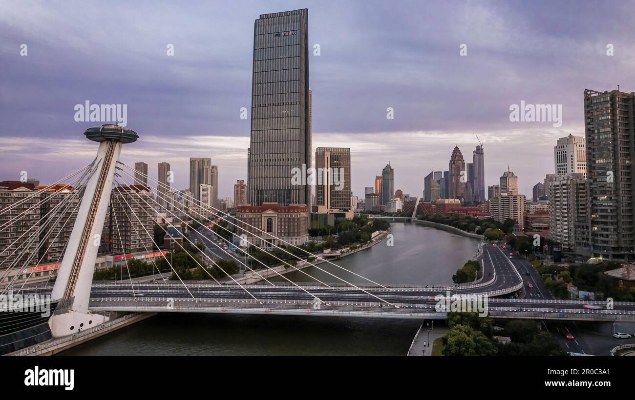 A stunning aerial view of a bustling metropolis by the Haihe River snaking through the cityscape ...