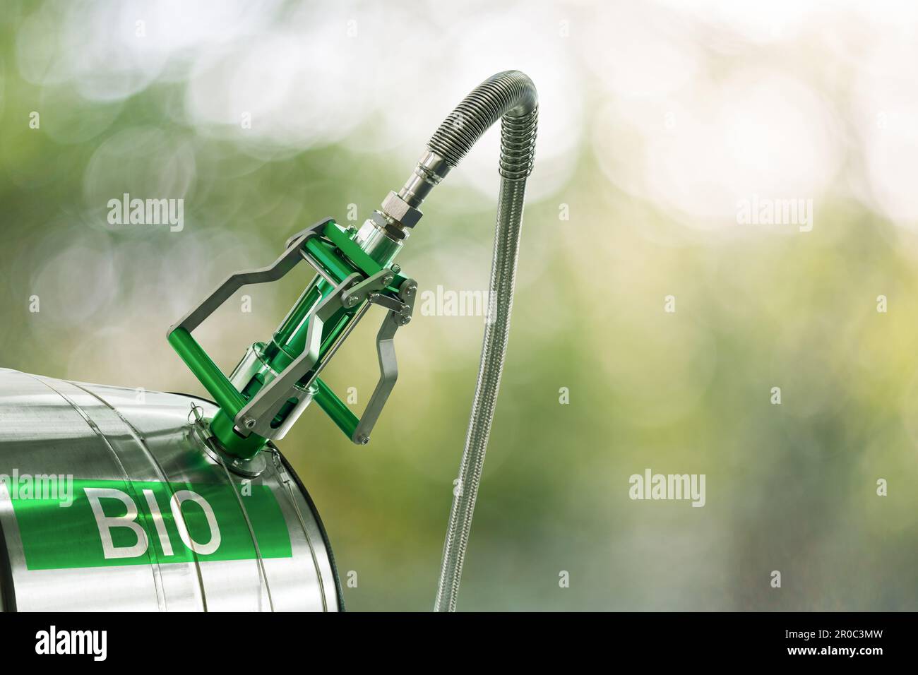 Biofuel filling nozzle with storage tank on a green background. High ...