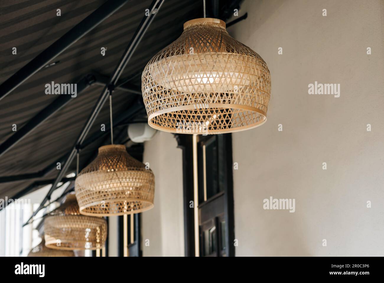 stylish hanging wicker lamps in a terrace or cafe Stock Photo - Alamy