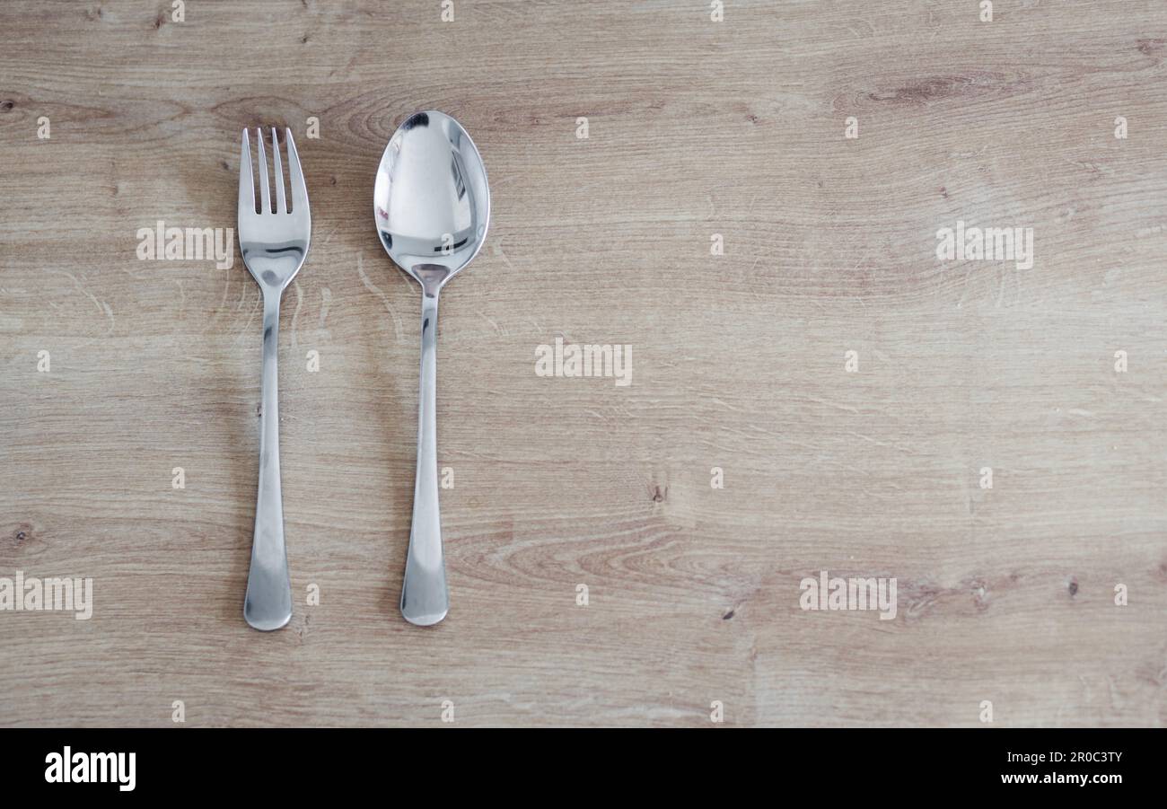 A top down view on a cutlery in wooden background. dining accessories ...