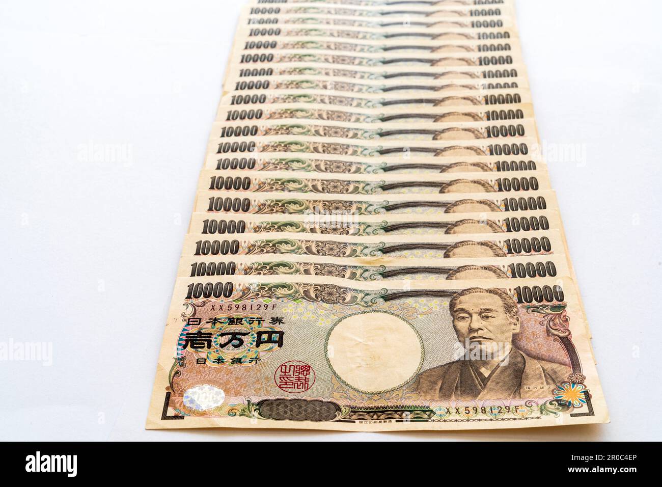 Japanese 10,000 yen banknotes overlapping each other in a long line on ...