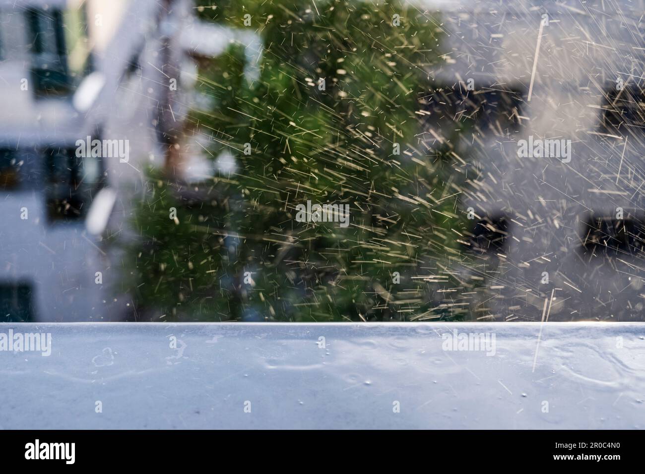 Rain sheets bouncing off a wet window sill Stock Photo - Alamy