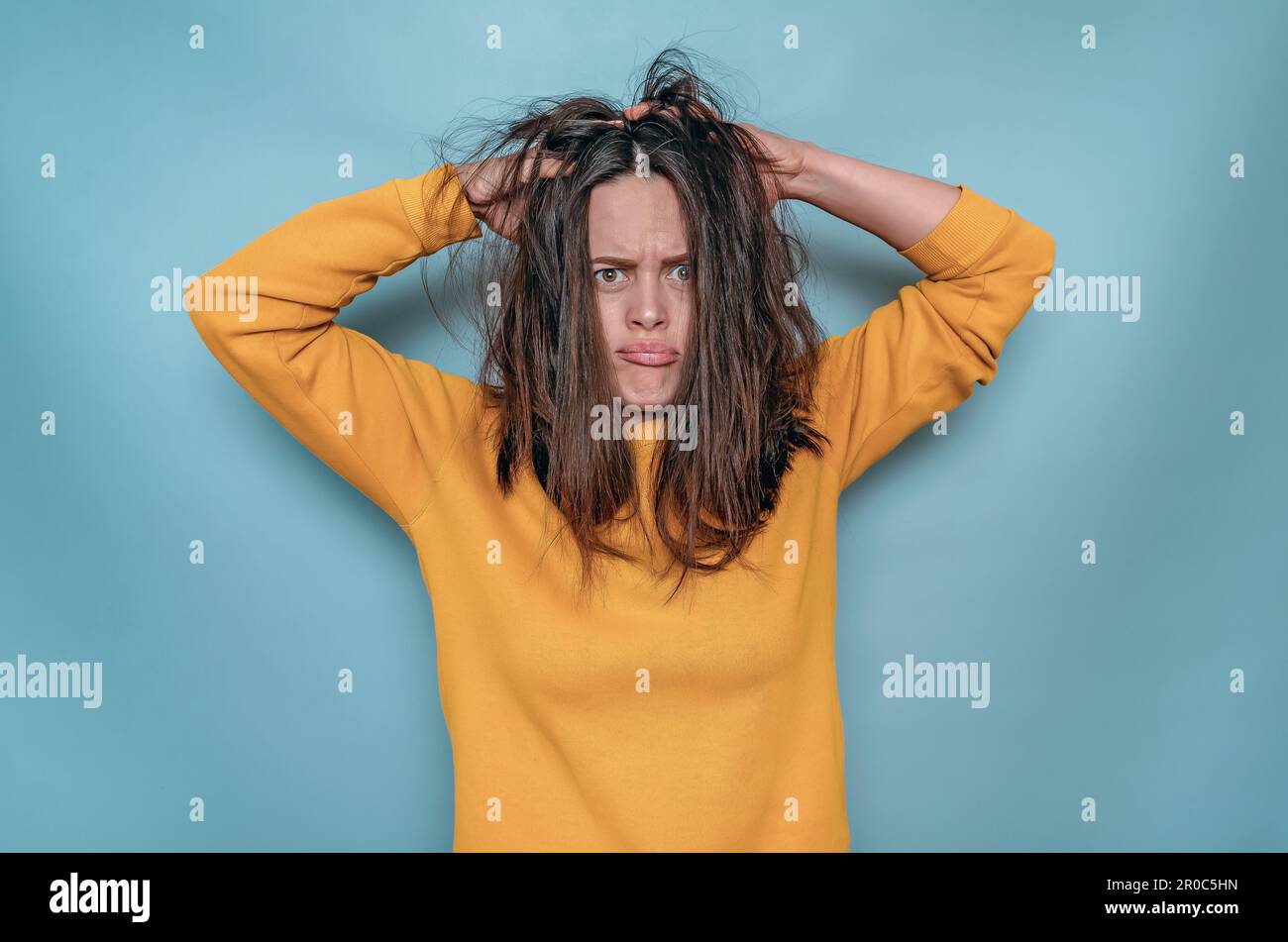 Amazed alarmed shocked disappointed woman. Black hair, yellow blouse ...