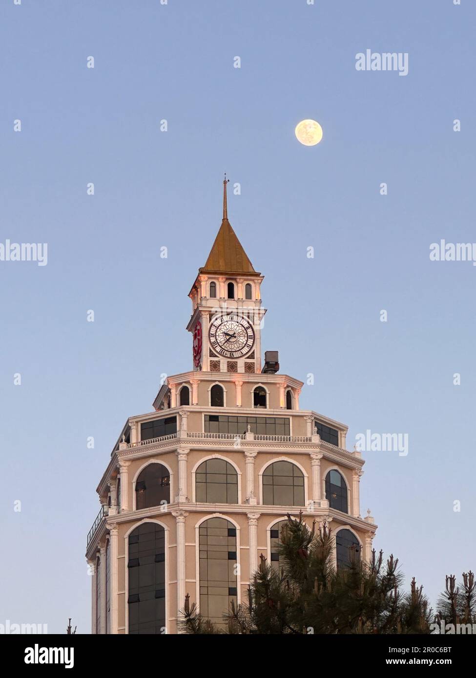 Full moon over clock tower twilight Stock Photo - Alamy