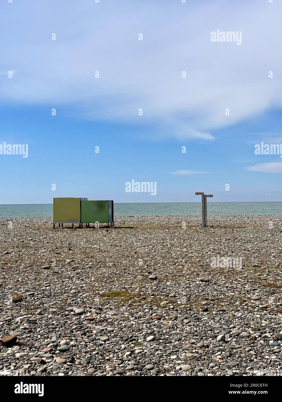 Cabins for changing clothes and showers on a pebble beach by the sea ...